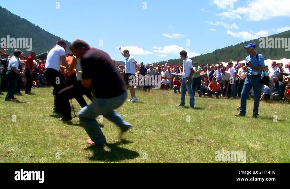 Men compete in a rope pulling" "Tug Of War" on village games Stock ...