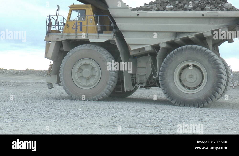 Heavy mining dump trucks moving along the opencast Stock Video Footage ...