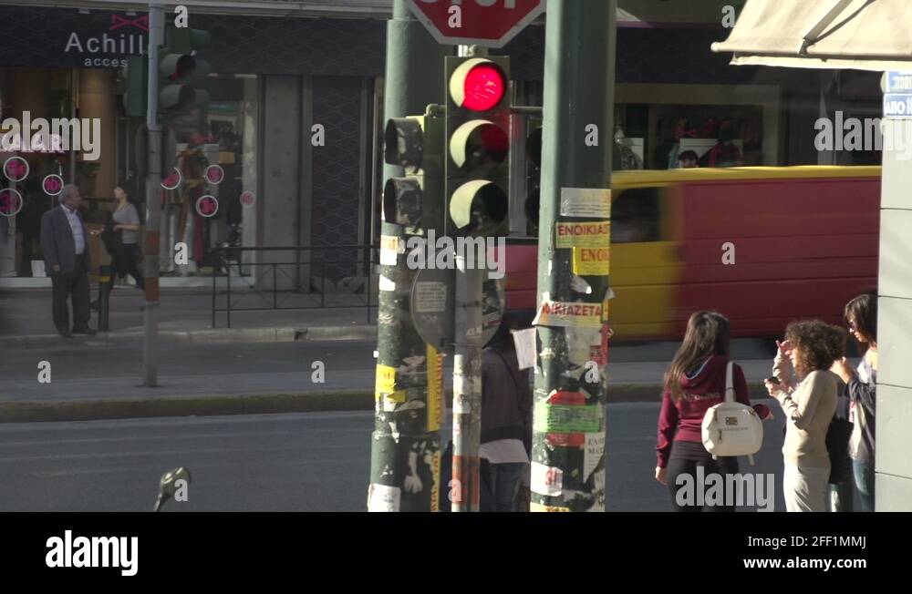 Athens gritty street corner, lights change from red to green, traffic ...