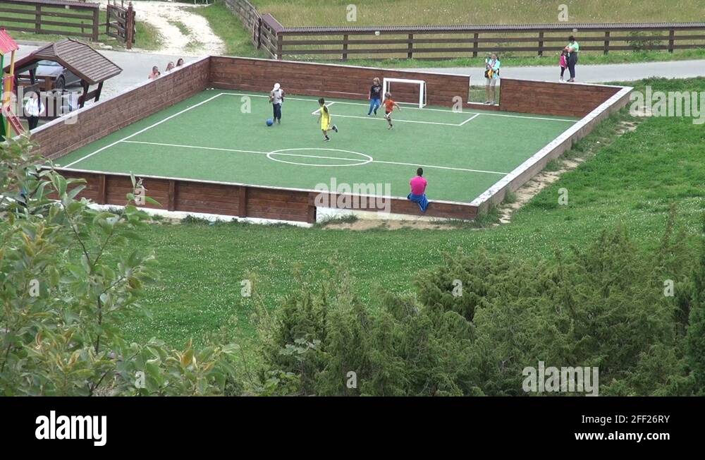 Children playing football game on a football field, soccer, playground ...