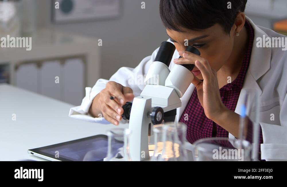 Black doctor looking through microscope Stock Videos & Footage - HD and ...