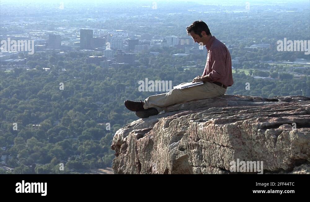 Man sitting on cliff Stock Videos & Footage - HD and 4K Video Clips - Alamy