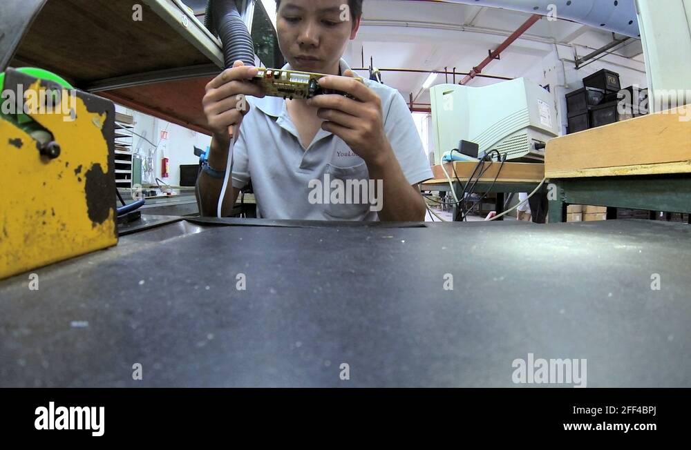 Precision quality control checks Chinese worker PCBs, China Stock Video ...