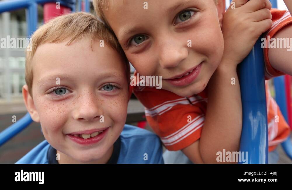 Two young boys at playground making silly faces Stock Video Footage - Alamy