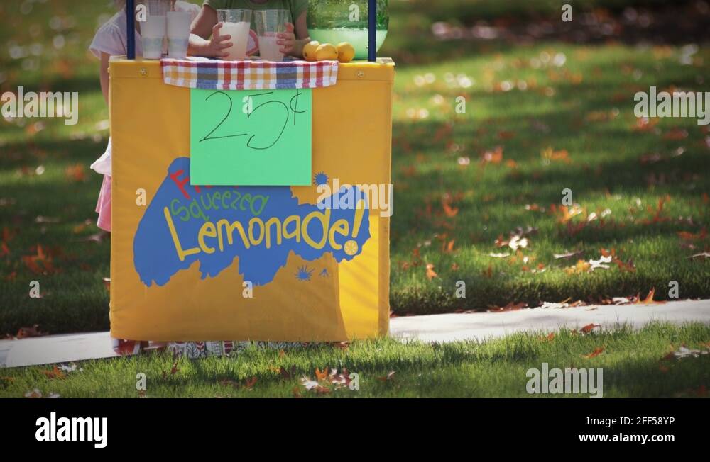 Two young girls at a lemonade stand, cheers with lemonade Stock Video ...