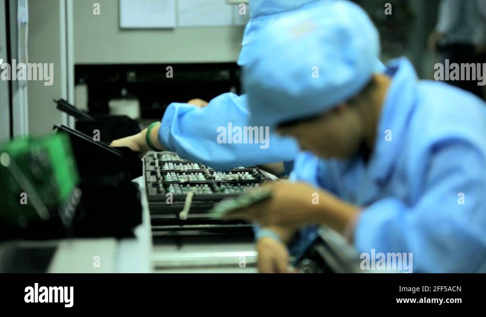 Assembly line technology Chinese worker producing PCBs, China Stock ...