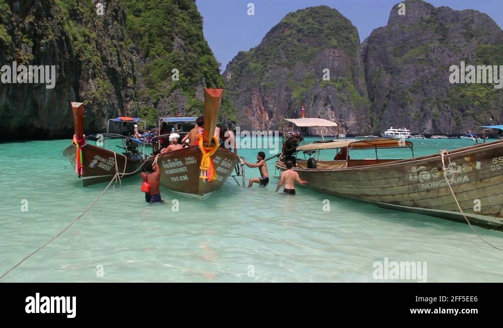 Pan from boats at the beach at Phi Phi island Stock Video Footage - Alamy