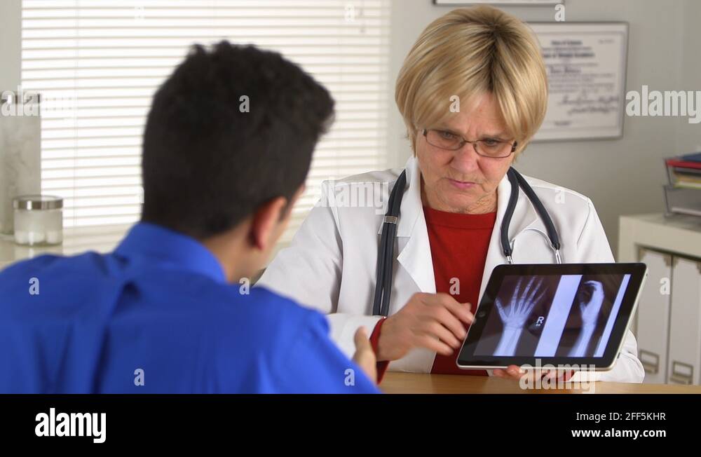 Doctor explaining xray to hispanic patient Stock Video Footage - Alamy