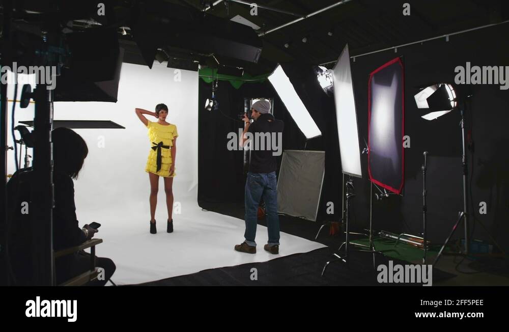Behind the scenes of a female model being photographed by a male ...