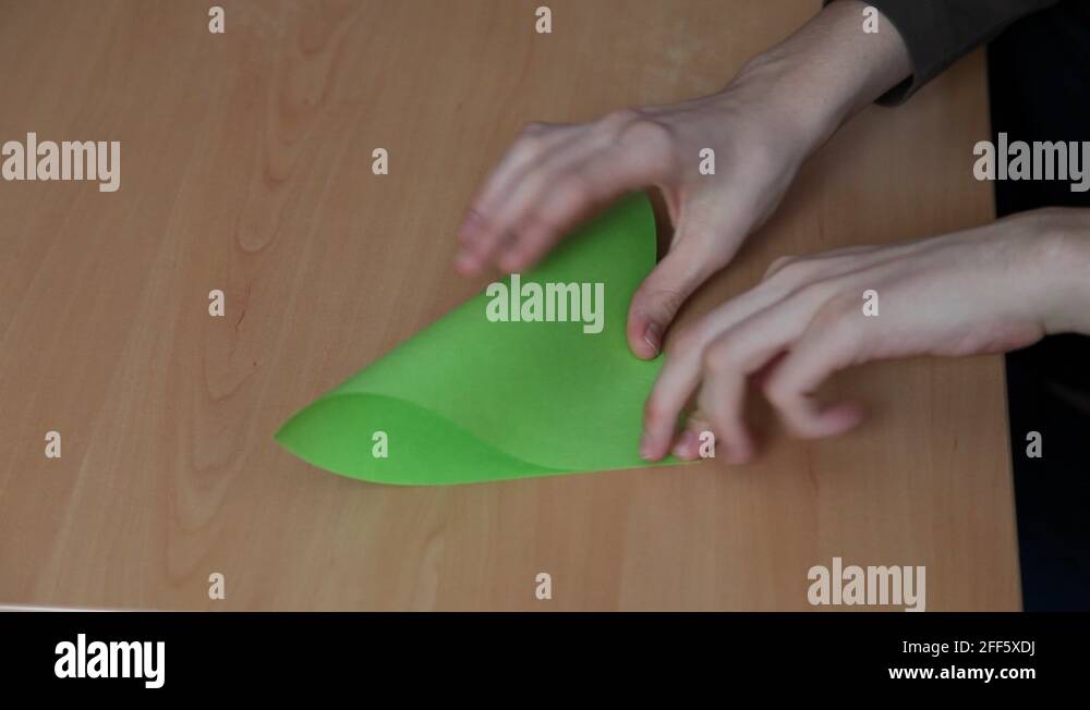 Making an origami pinwheel, traditional Japanese art of paper folding ...