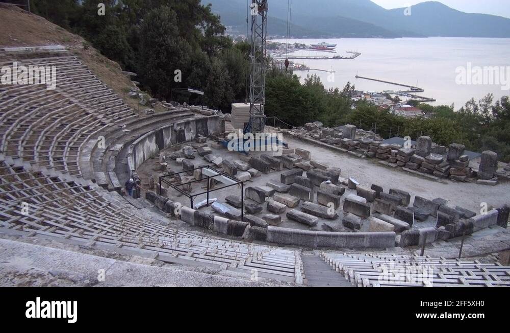 Ancient Amphitheater in Greek island, Thassos, tourist taking pictures ...