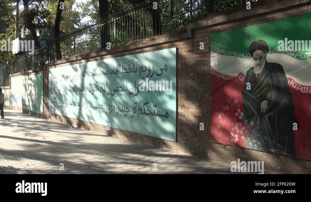 Iran, Tehran, people walk past former US Embassy compound Stock Video ...