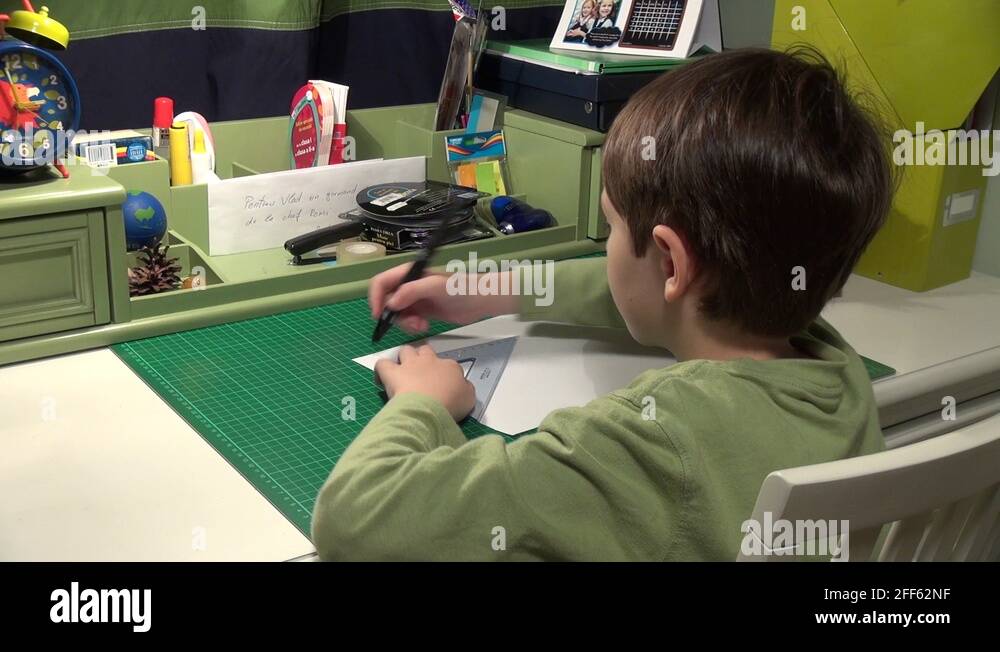 Little boy drawing at math, child works at his desk, school boy doing ...