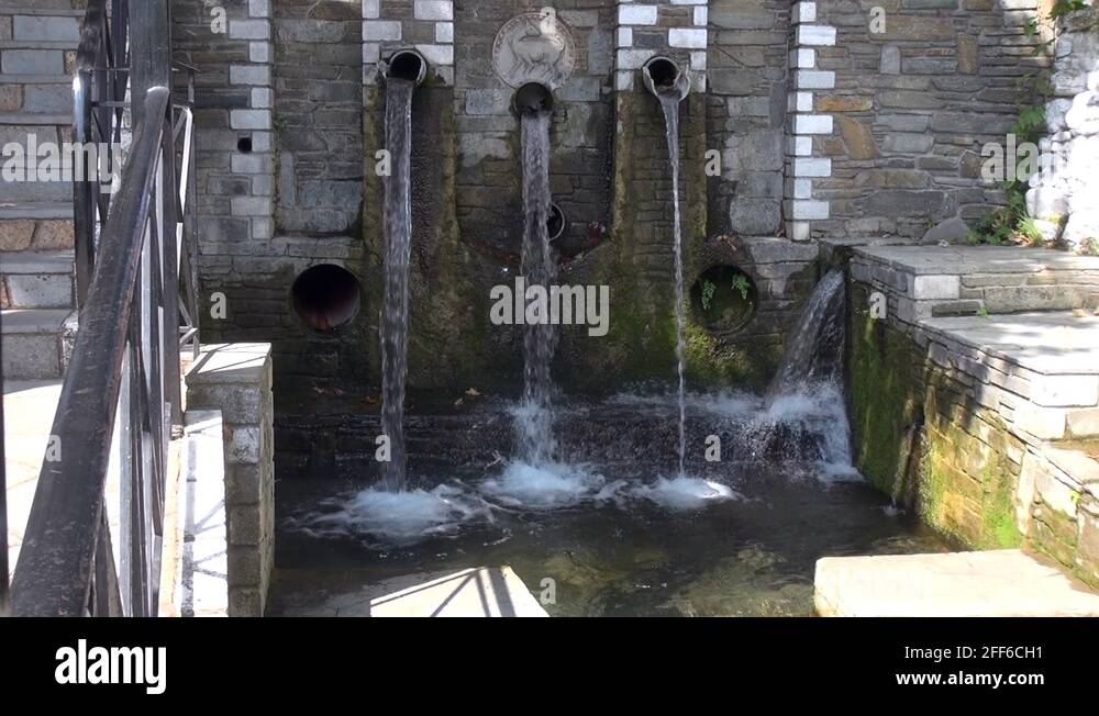 Clear spring jet of water flowing from pipes, fresh drinking water ...