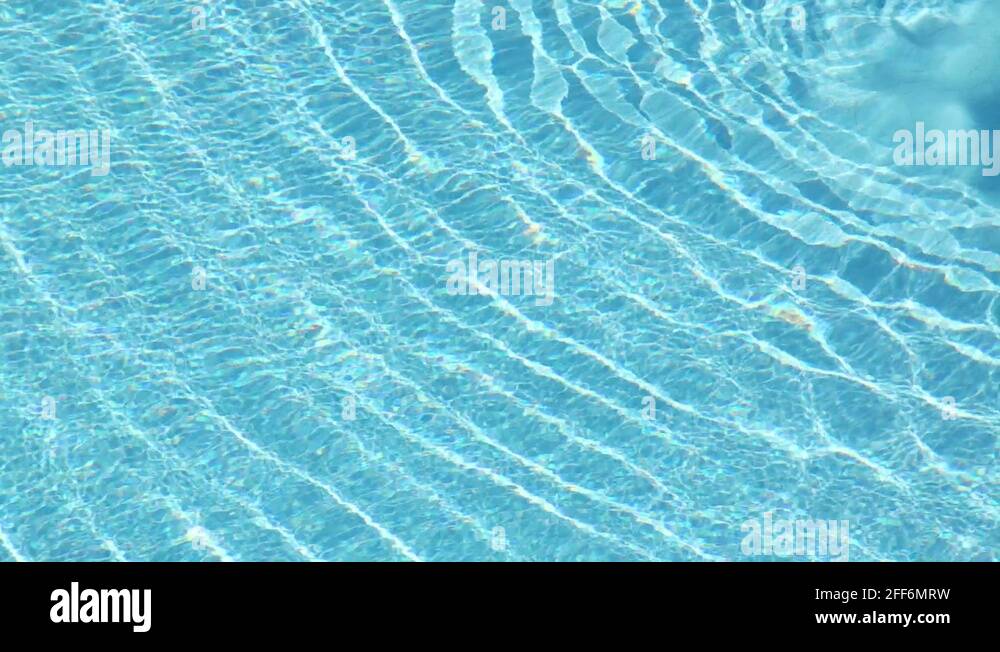 Little boy swims in pool, making ripple on water surface Stock Video ...