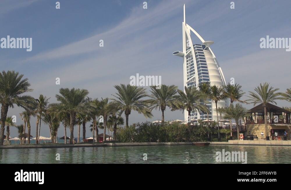 Burj Al Arab hotel palm tree reflection water blue sky luxurious ...