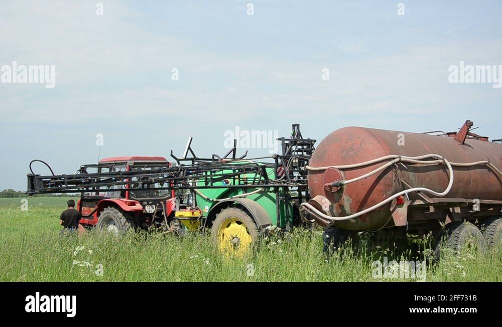 tractor moves to spray fields from pests Stock Video Footage - Alamy