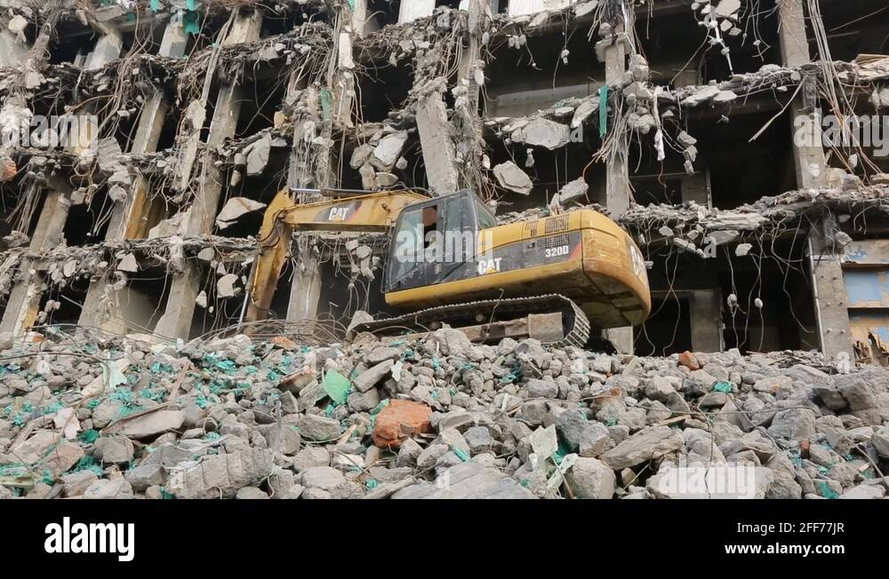 Robotic arm of a large machine demolishing a city building Stock Video ...