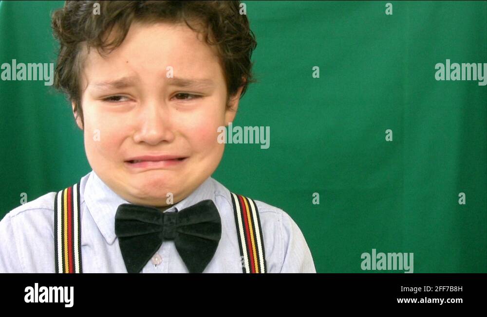 Boy crying in front of a green screen Stock Video Footage - Alamy