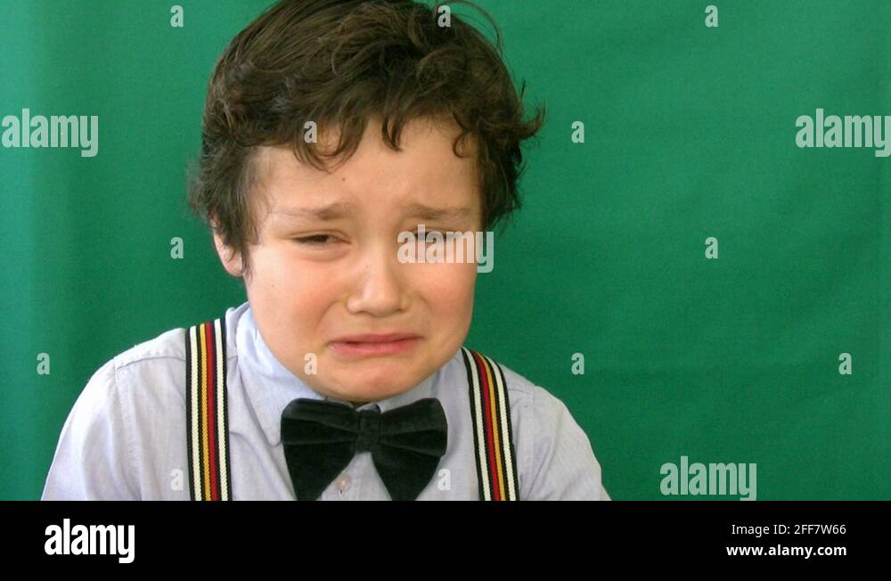 Boy crying in front of a green screen 2 Stock Video Footage - Alamy
