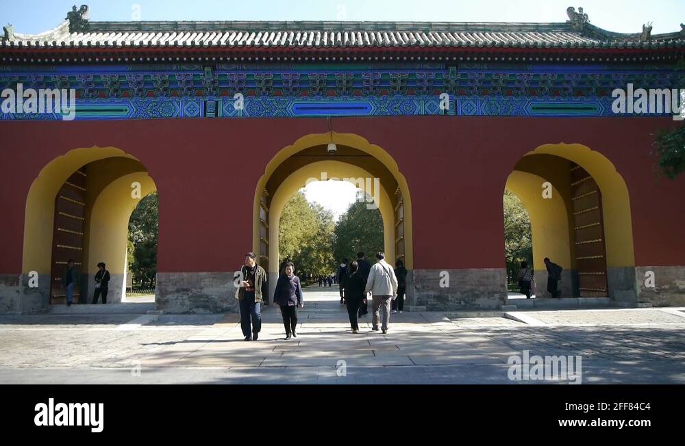 Asian People walk in cypress trees park,China Beijing red door ancient ...