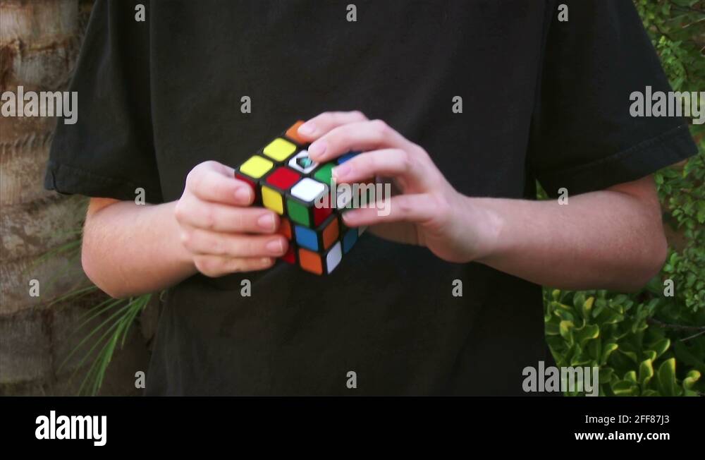Teenage boy trying to solve a Rubik's Cube Stock Video Footage - Alamy