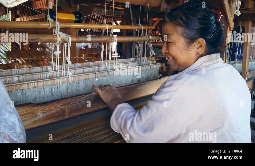 Local village Burmese asian woman works on weaving loom machine at ...