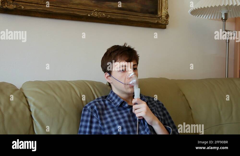 Teenage boy using nebulizer, inhaler, asthma, respiratory diseases ...