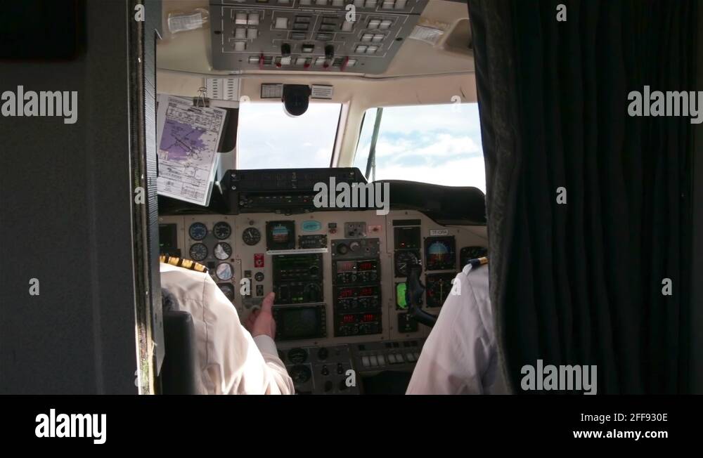 airplane cockpit controls, mountain view out window, pilots talking ...