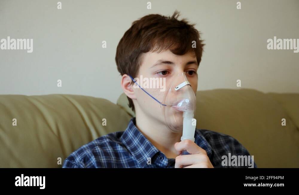 Teenage boy using nebulizer, inhaler, asthma, respiratory diseases ...