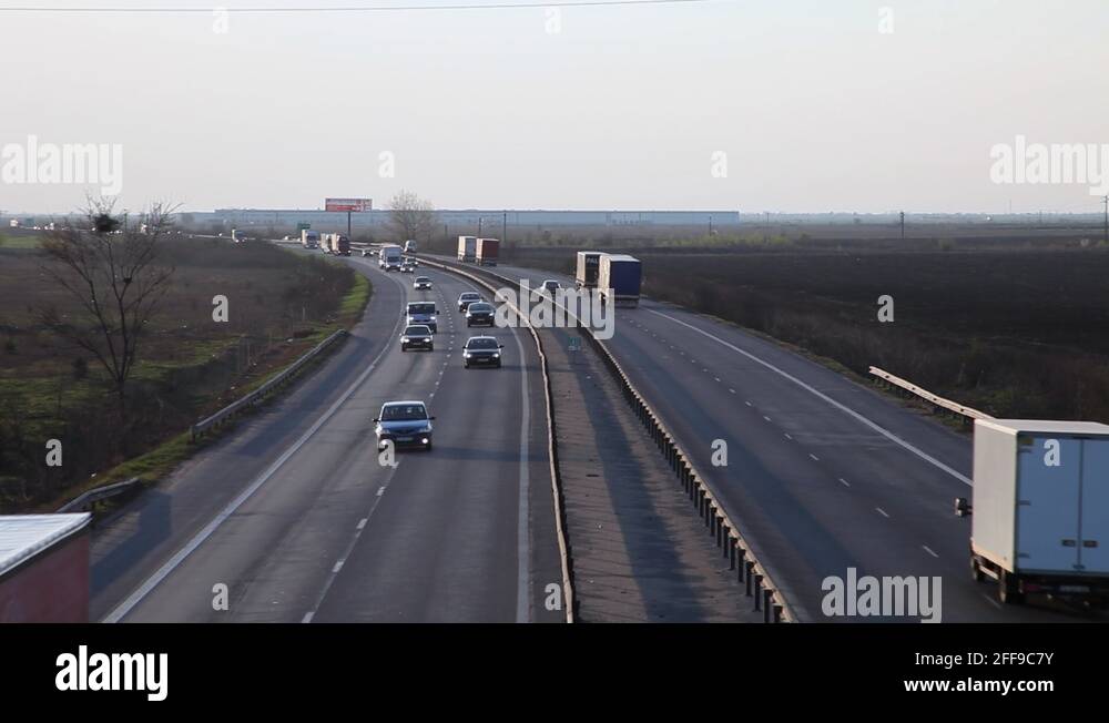 Cars, trucks on highway, motorway, expressway, evening traffic, time ...
