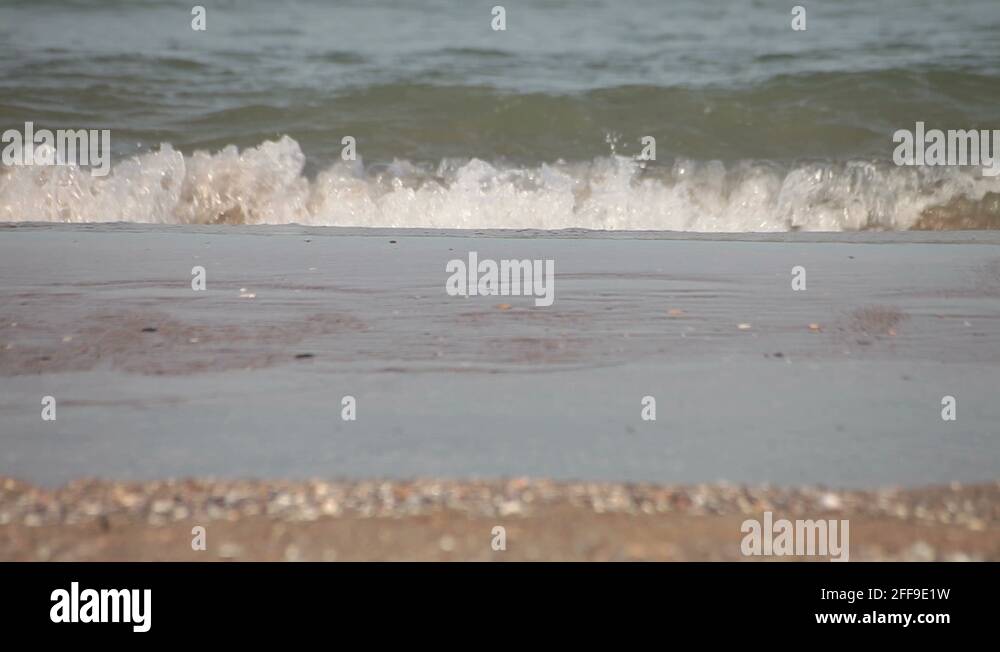 ocean waves washing beach sand Stock Video Footage - Alamy