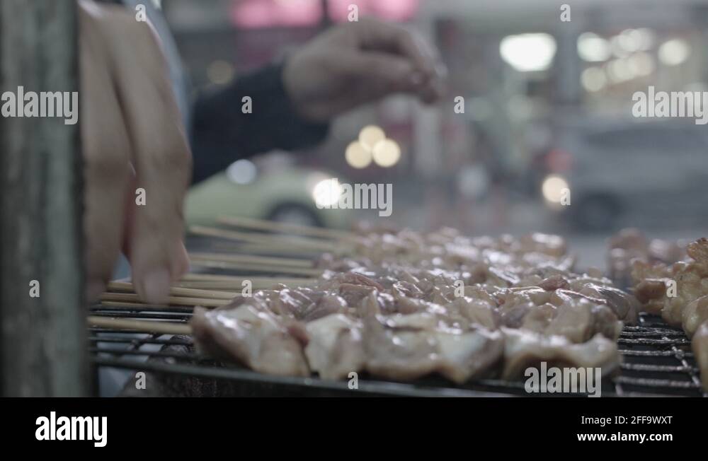 Turn Skewers At A Snack Shop On A Busy Street In Bangkok - Thailand ...