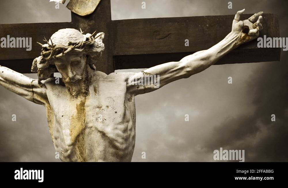 Crucifixion. Christian cross with Jesus Christ statue over stormy clouds Stock Video Footage - Alamy