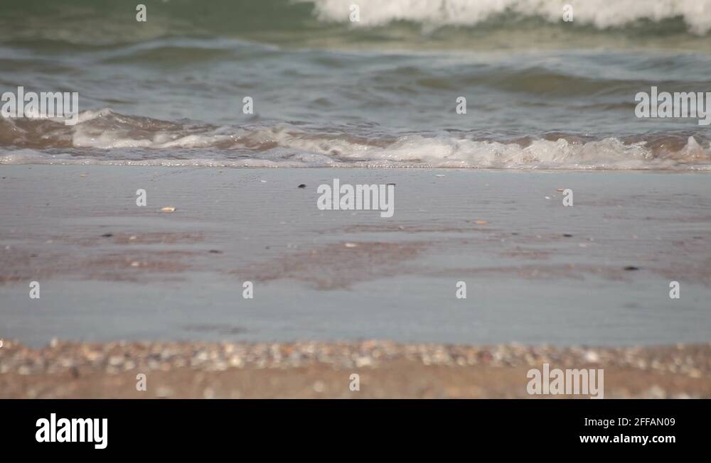 ocean waves washing beach sand Stock Video Footage - Alamy