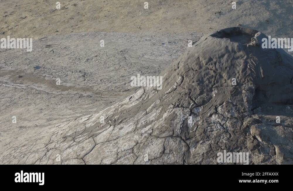Closeup mud volcano gas eruption crater ground liquid lava muddy field ...