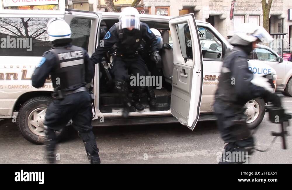 Riot police officers in full gear exit police van Stock Video Footage ...