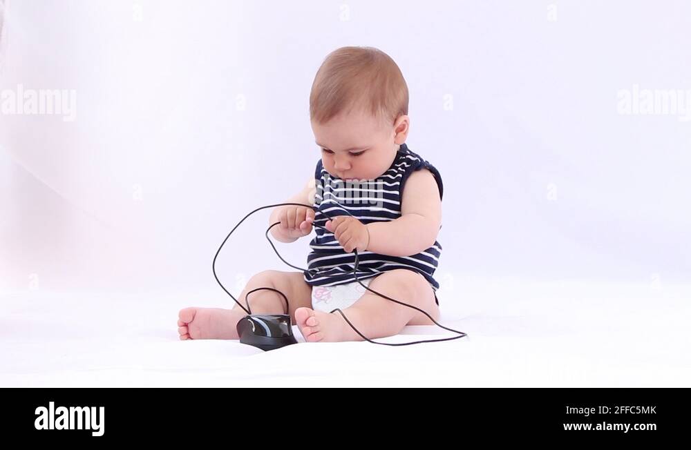 Hi Tech Baby. Boy playing with a computer mouse against white ...