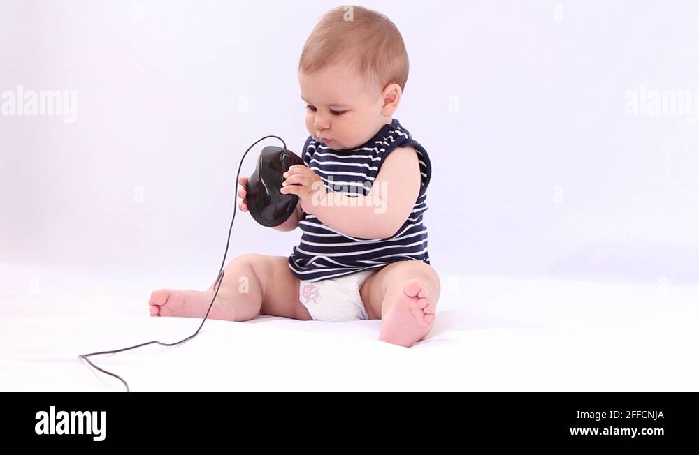 Hi Tech Baby. Boy playing with a computer mouse against white ...