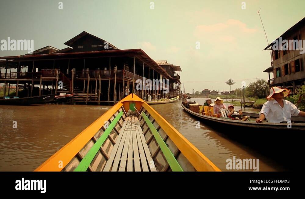 Boats go by a floating village at Inle Lake, Myanmar Stock Video ...