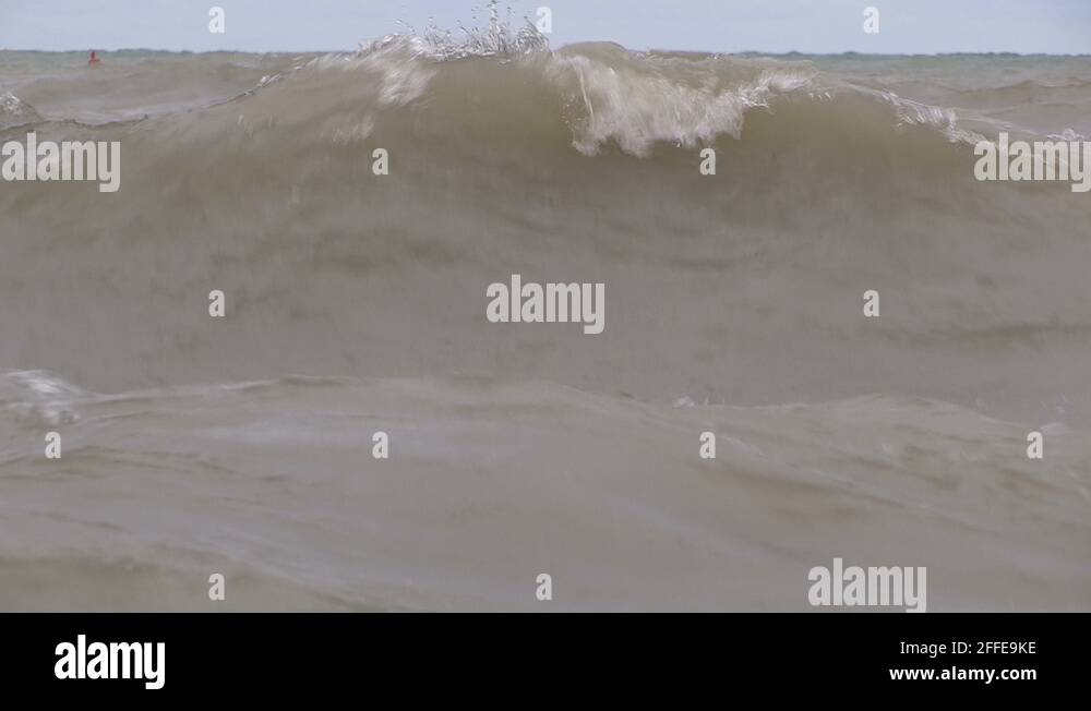 Intense waves rolling in and breaking during storm with hurricane force ...
