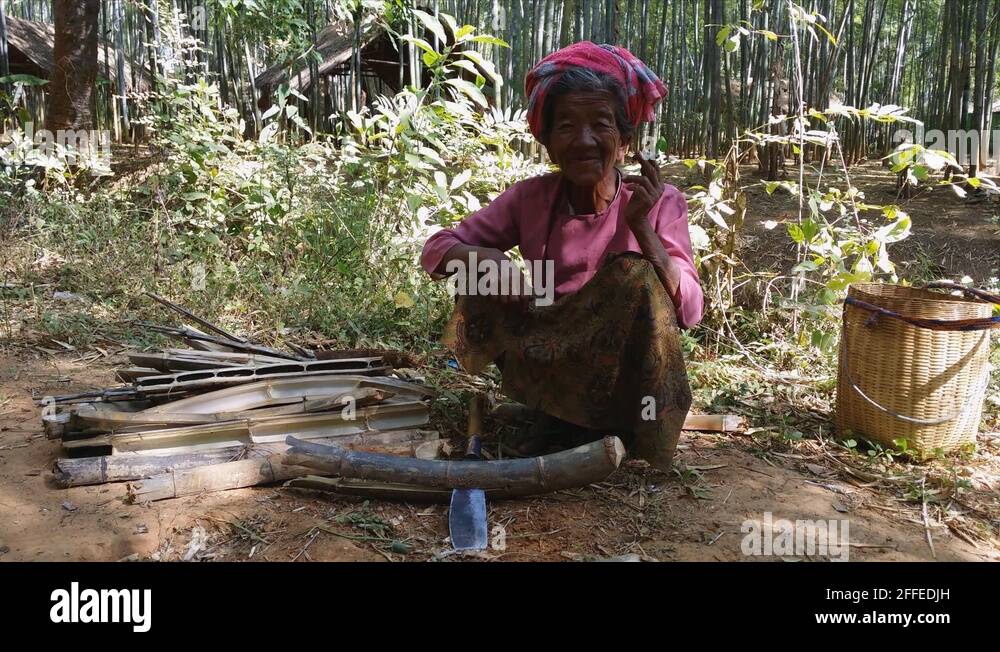 Old and poor asian woman from local ethnic tribe in traditional clothes ...