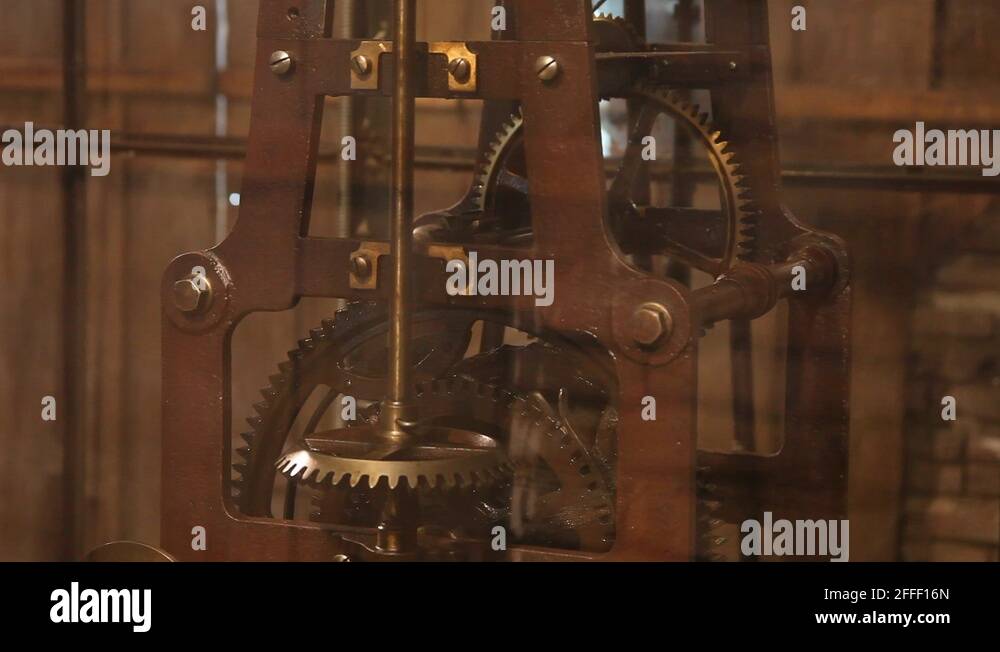 Very old clock tower mechanism,gears moving,measuring time, pendulum ...