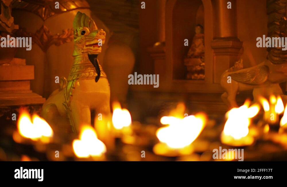 statues of mythical monsters in a buddhist temple at night. ritual ...