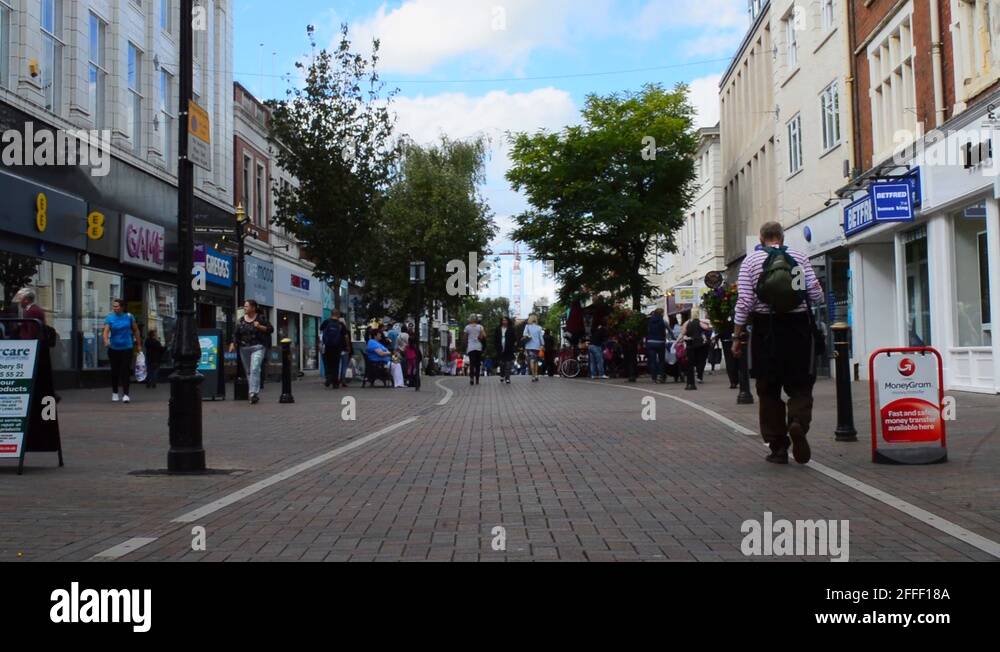 People Walk Through a Busy Town Centre Stock Video Footage - Alamy