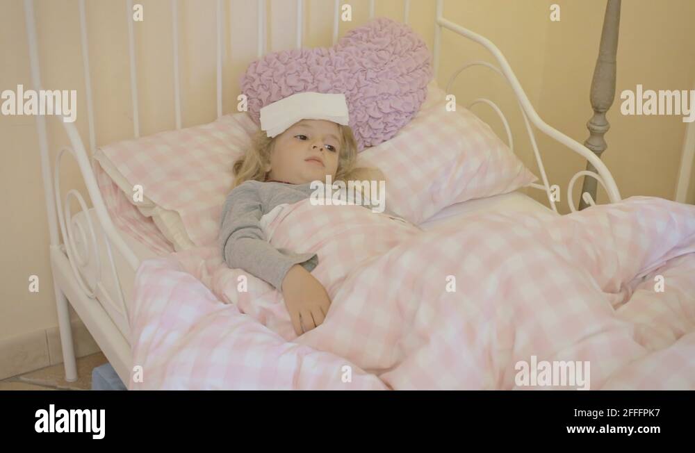 Little girl sick in bed calls mummy 2 Stock Video Footage - Alamy