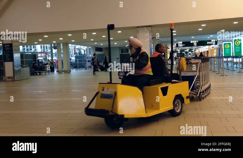 airport workers moving stacks of luggage carts Stock Video Footage - Alamy