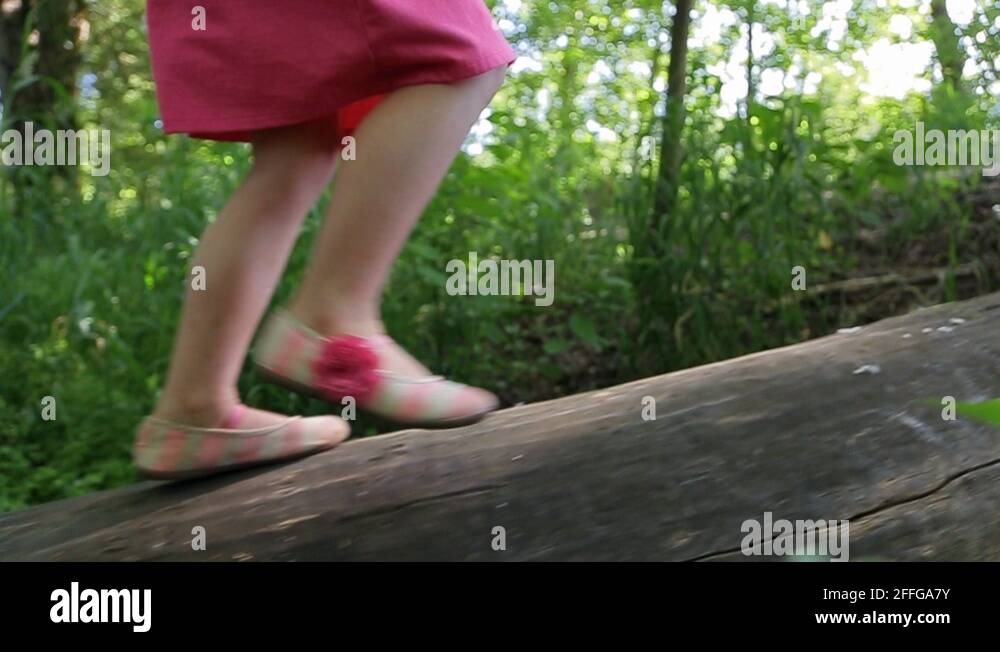Little Girls Legs Running Across A Log (Camera Follows Along From Left ...