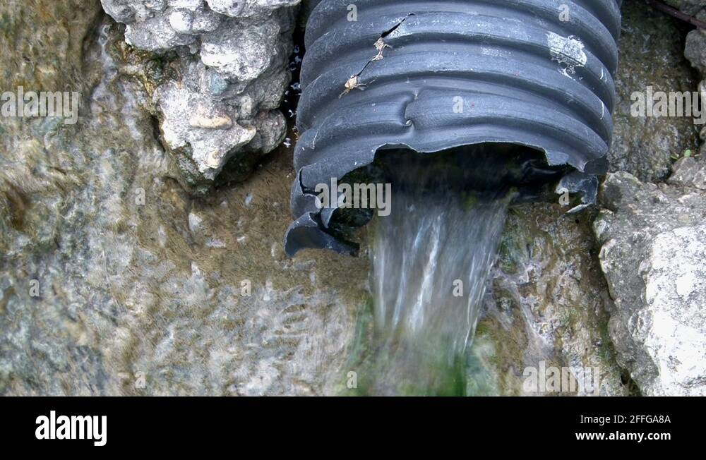 Hose plastic drain water rocks cesspool conduit culvert ditch duct ...