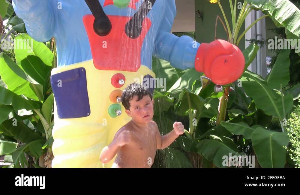 Happy child taking a cold shower in a waterpark Stock Video Footage - Alamy
